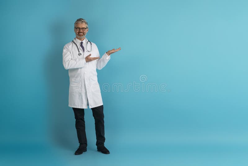 Cheerful Grey-haired Doctor Pointing at Copy Space on Blue Stock Photo ...
