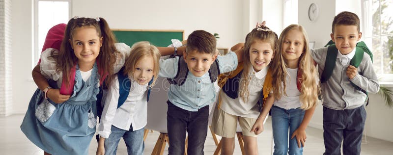 Cheerful Group of Elementary School Students with Backpacks on Their ...