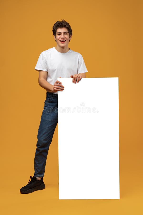 Cheerful Guy Demonstrate Empty Space Blank Offer on Yellow Background ...