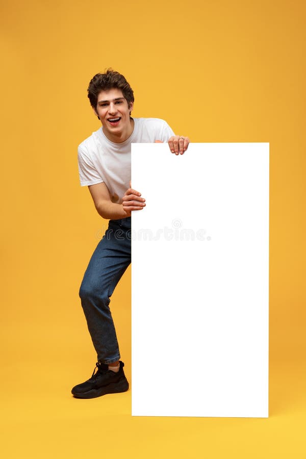 Cheerful Guy Demonstrate Empty Space Blank Offer on Yellow Background ...