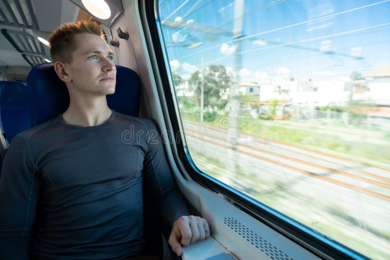 Cheerful Guy Looking Out of a Train Window, Smiling Stock Photo - Image ...