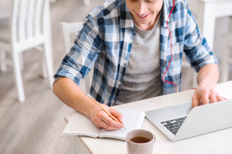 Cheerful guy making notes stock photo. Image of cafe - 68833242