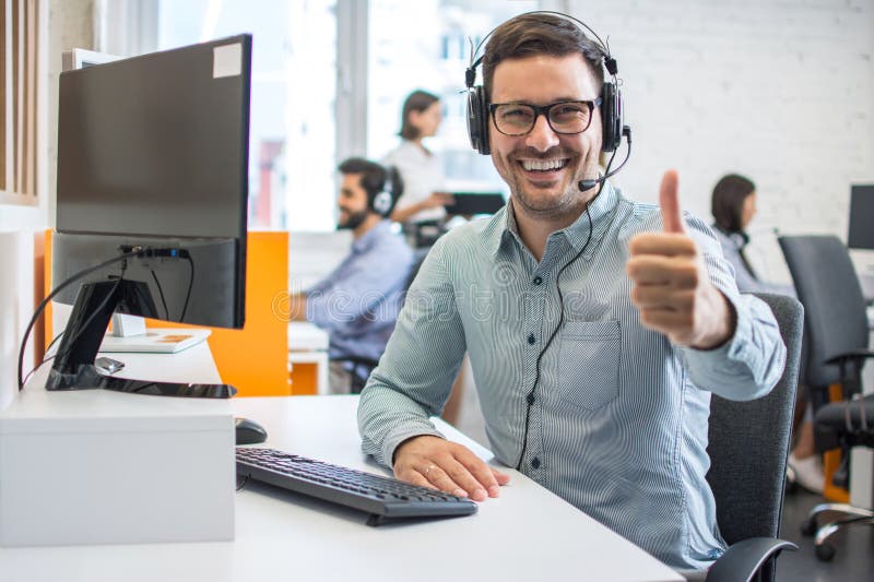 Cheerful Handsome Call Center Worker Showing Thumbs Up in a Call Center ...