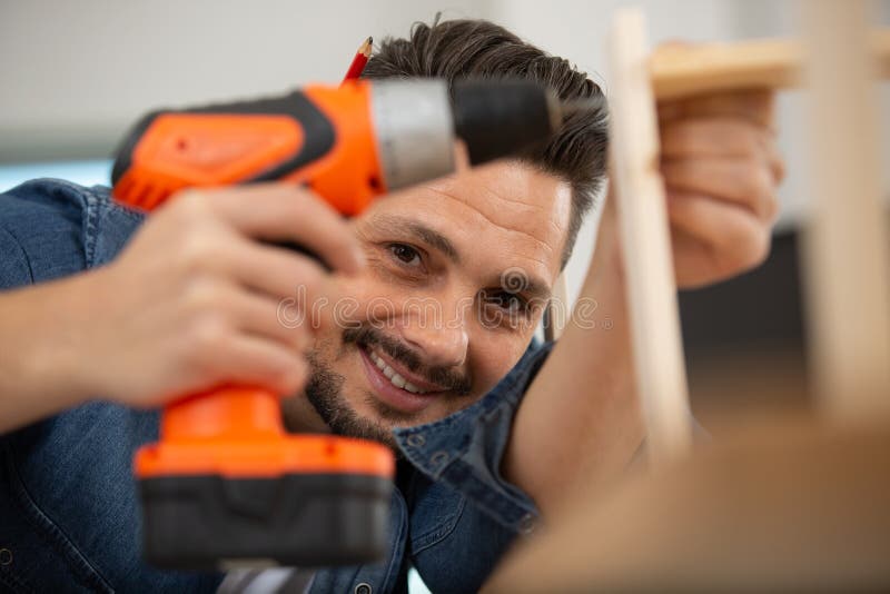 Cheerful Handyman Using Cordless Screwdriver Stock Image - Image of ...