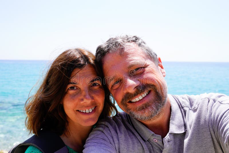 Cheerful Happy Tourist Couple Middle Aged Taking Selfie In Vacation On
