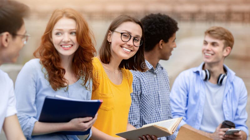 Cheerful High-School Students Talking during Break Sitting and Learning ...