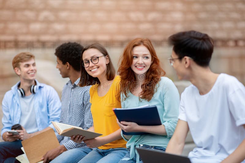 Cheerful High-School Students Talking during Break Sitting and Learning ...