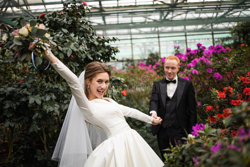 Cheerful Hugging Just Married in the Lovely Garden. Stock Photo - Image ...