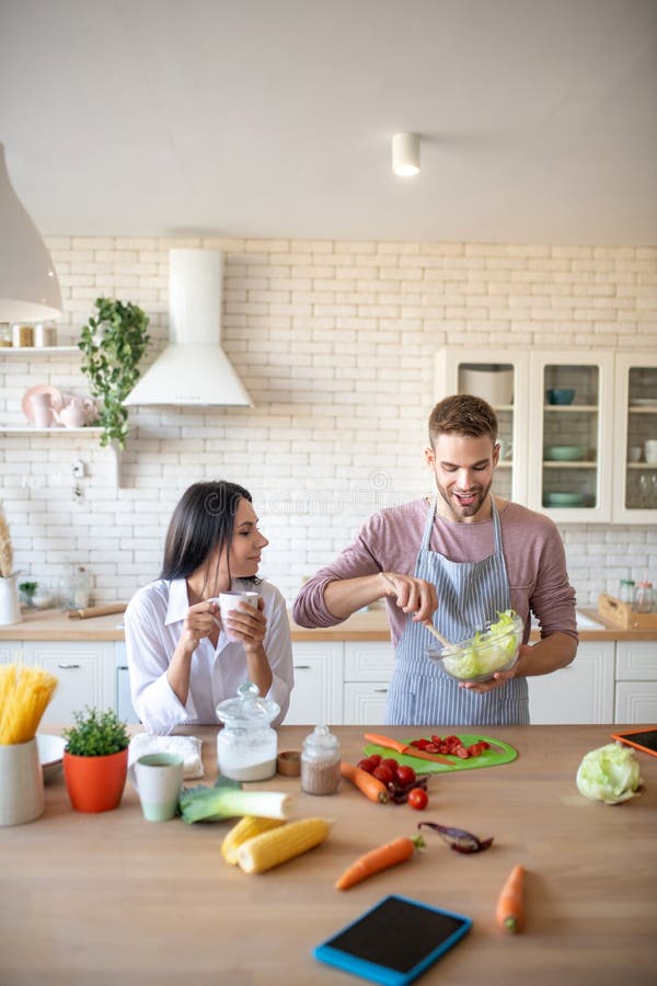 Cheerful Husband Feeling Good while Cooking for His Wife Stock Image ...