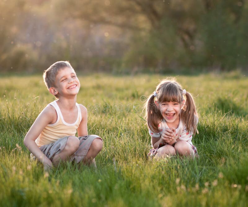 Three Kids Playing on a Grass Stock Image - Image of kids, look: 42628363