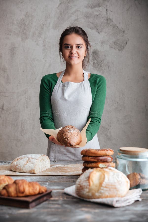 Cheerful Lady Baker Standing and Holding Bread Stock Image - Image of ...