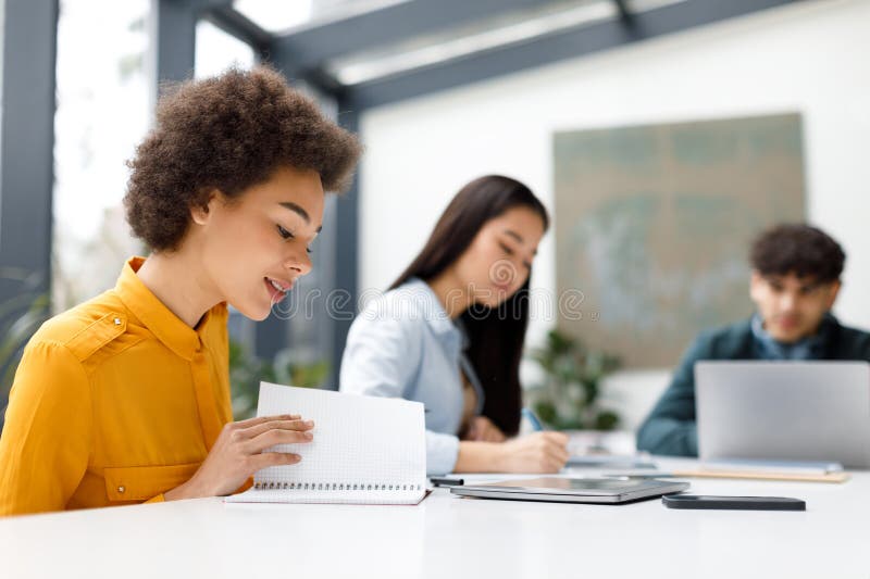 Cheerful Latin Female Student Studying in Classroom with Groupmates ...