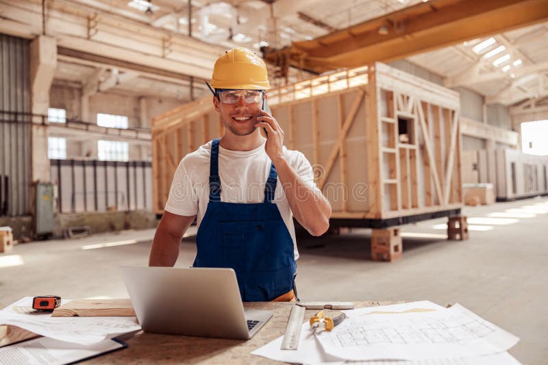 Cheerful Male Builder Talking on Cellphone at Work Stock Photo - Image ...