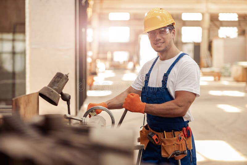 Cheerful Male Builder Using Professional Equipment in Workshop Stock ...