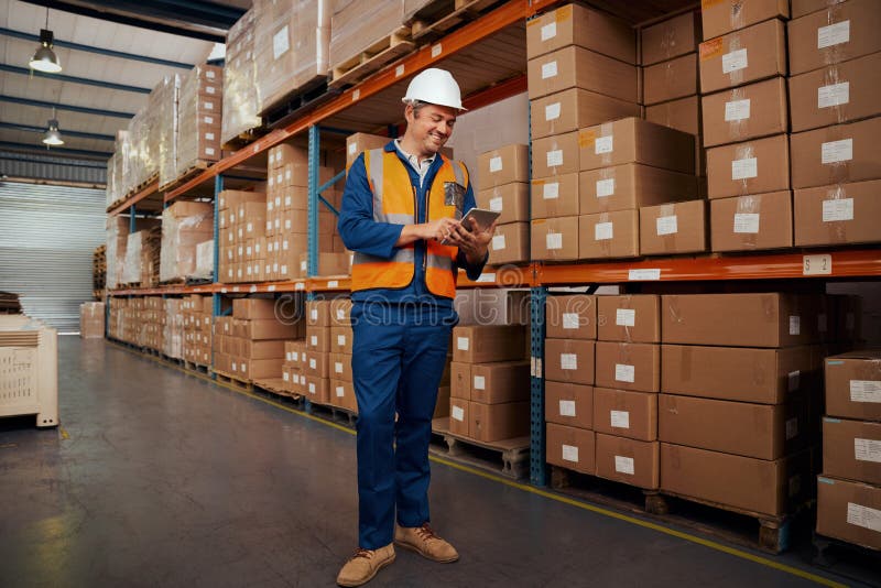 Cheerful Male Warehouse Supervisor Standing in Warehouse Using Smart ...