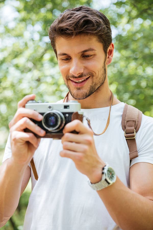 Cheerful Man with Backpack Taking Pictures Using Vintage Camera ...