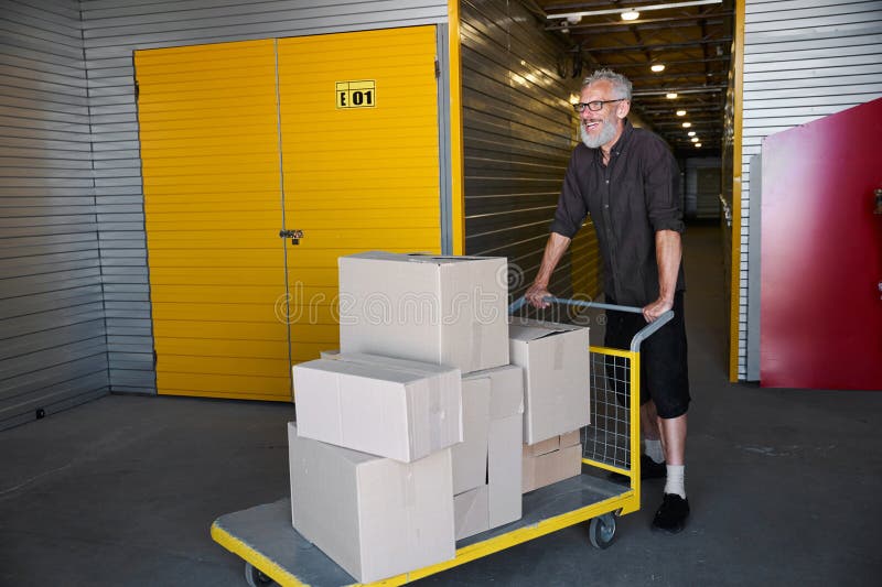 Cheerful Man is Carrying Lot of Boxes on Cargo Cart Stock Photo - Image ...