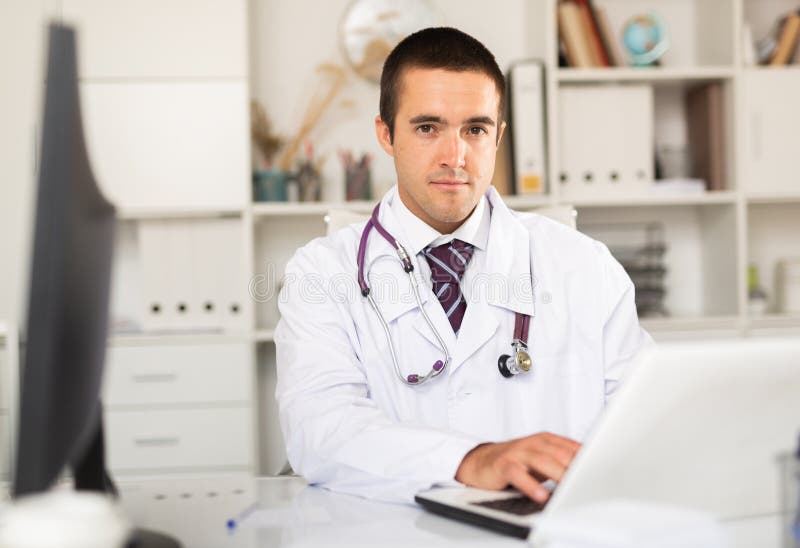Cheerful Man Doctor Working Effectively in Office Stock Photo - Image ...