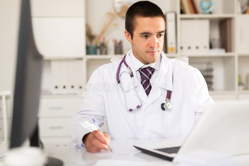 Cheerful Man Doctor Working Effectively in Office Stock Photo - Image ...