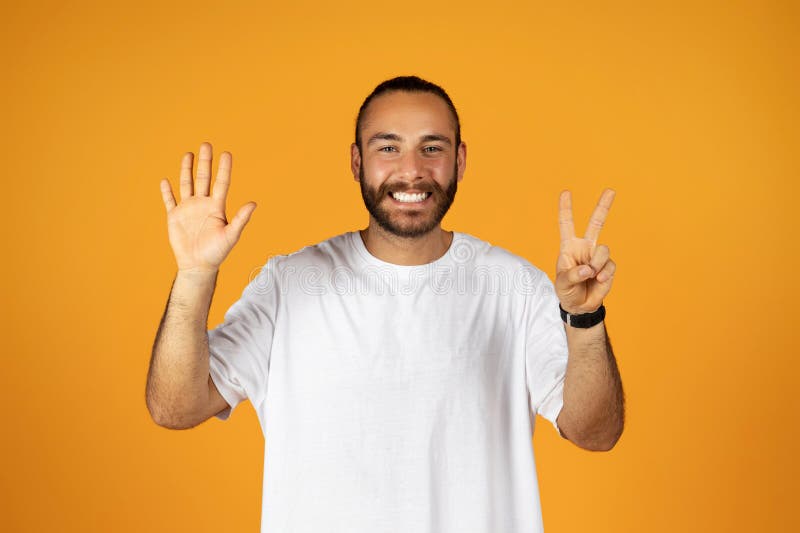 Cheerful Man Holding Up Five Fingers and Peace Sign on Orange Backdrop ...