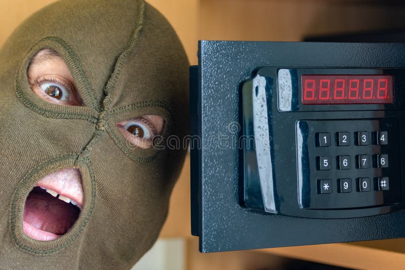 A Cheerful Man in a Mask Celebrates Success by Opening a Safe Stock ...