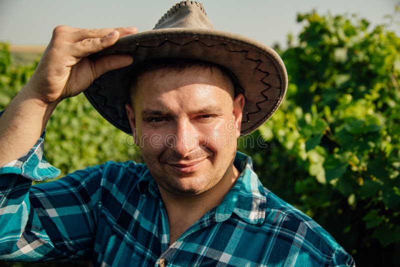 Cheerful Man with Modern Young Winemaker Hat is on the Vineyard. Stock ...