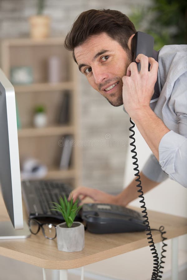 Cheerful Man in Office Answering Phone Stock Image - Image of adult ...