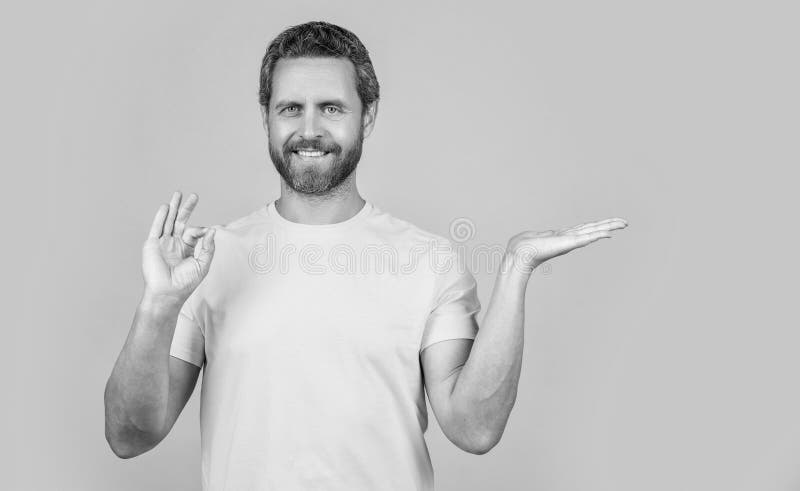 Cheerful Man Presenting Advertisement in Studio, Ok. Photo of Man ...