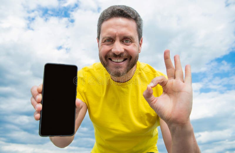 Cheerful Man Presenting Screen of Smartphone with Copy Space Stock ...