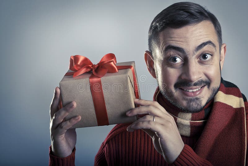 Cheerful Man Shaking the Gift Box and Smiling. Stock Photo - Image of ...