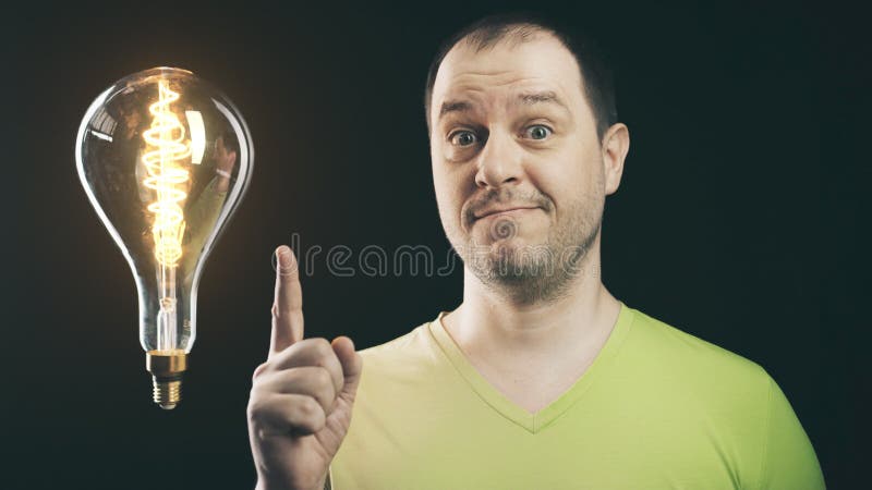 Big Shining Light Bulb and Happy Man Stock Photo - Image of bright ...
