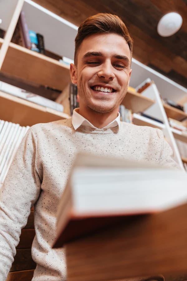 Cheerful Man Sitting in Cafe while Reading Book Stock Image - Image of ...