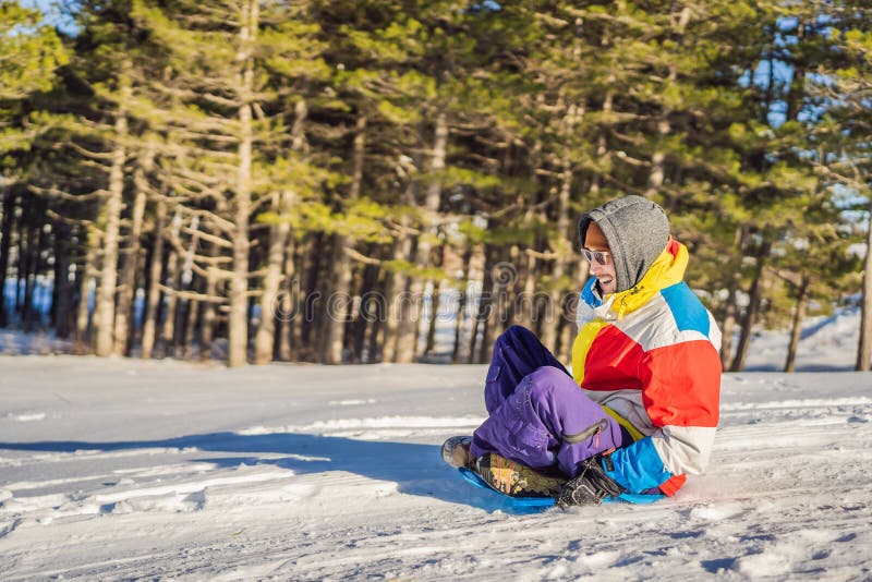 Cheerful Man Sledding Down a Snowy Slope in Full Speed Stock Image ...