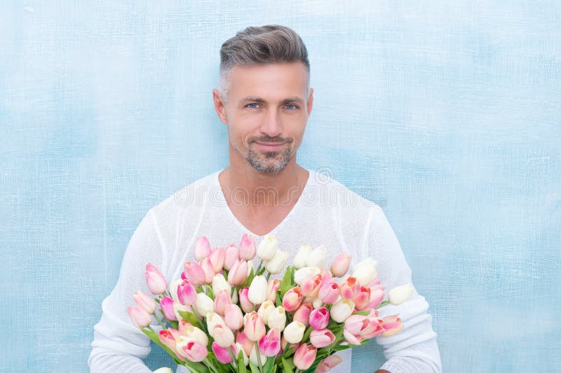 Cheerful Man with Spring Tulips in Studio. Man with Spring Tulips ...