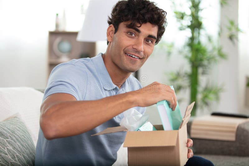 Cheerful Man Unpacking Delivery Books Stock Photo - Image of happy ...