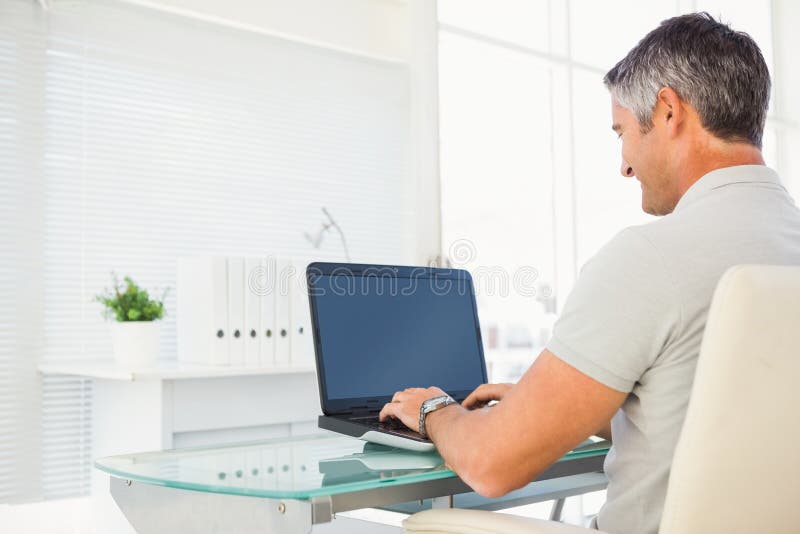 Cheerful Man Using His Laptop at Desk Stock Photo - Image of caucasian ...