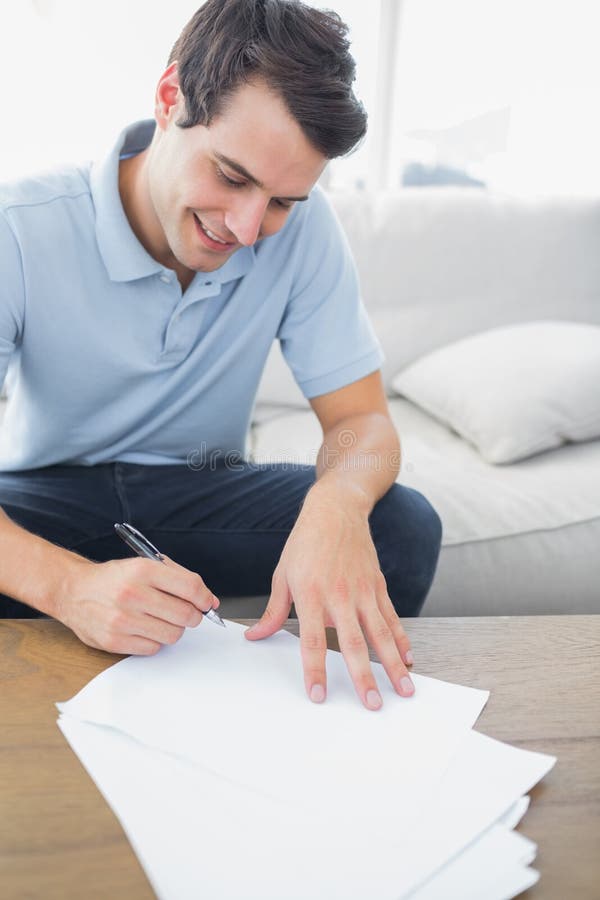 Cheerful Man Writing on a Paper Stock Image - Image of table, handsome ...