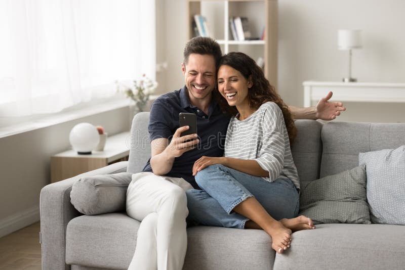 Cheerful Married Couple Using Application on Mobile Phone Stock Image ...