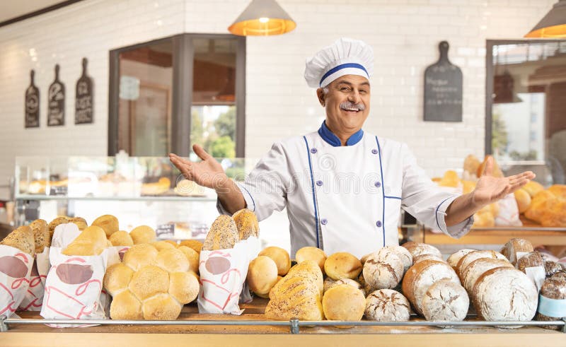 Cheerful Mature Baker Posing Stock Photo - Image of loaf, gesturing ...