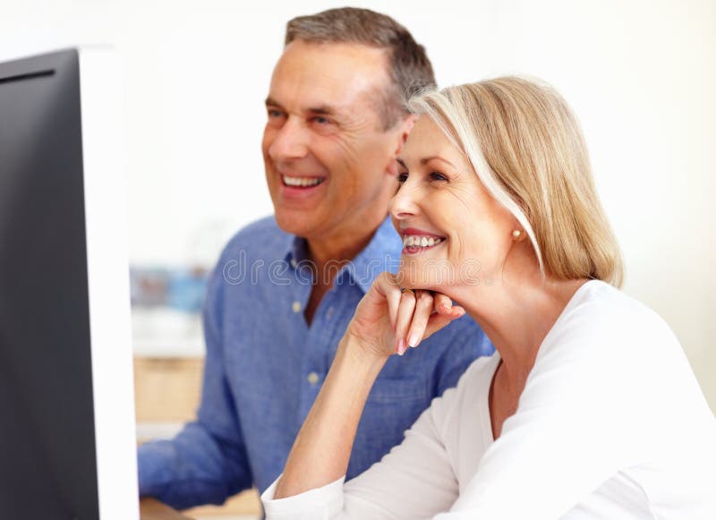 Cheerful Mature Couple Working on a Computer. Closeup Portrait of a ...