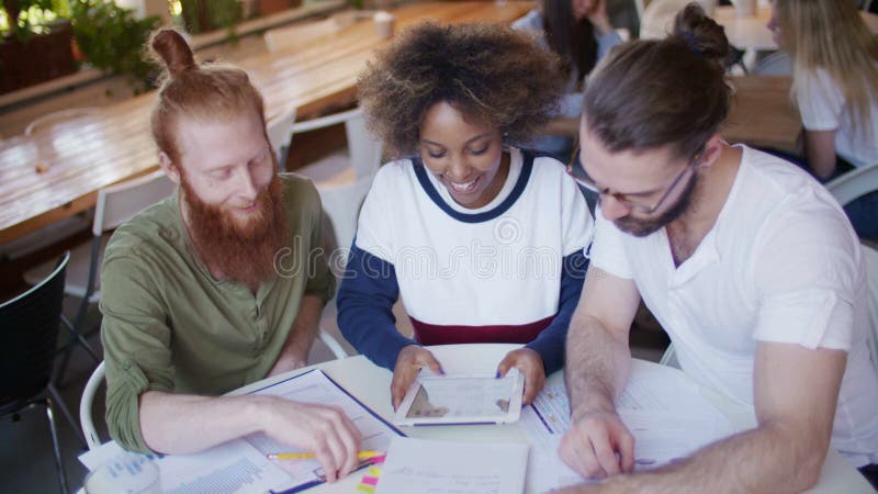 Cheerful Mixed International Student Group Chatting and Working ...