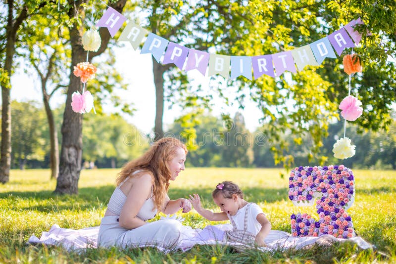 Cheerful Mother and Daughter Having Fun on Child Birthday on Blanket ... Cheerful Mother and Daughter Having Fun on Child Birthday on Blanket ...