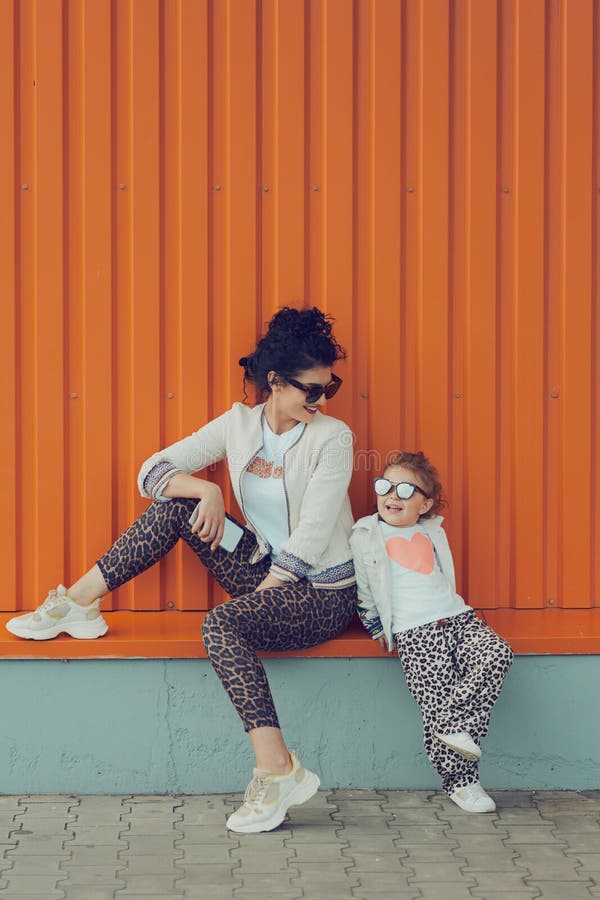 Cheerful Mother and Daughter Having Fun in City. Cute Little Girl ... Cheerful Mother and Daughter Having Fun in City. Cute Little Girl ...