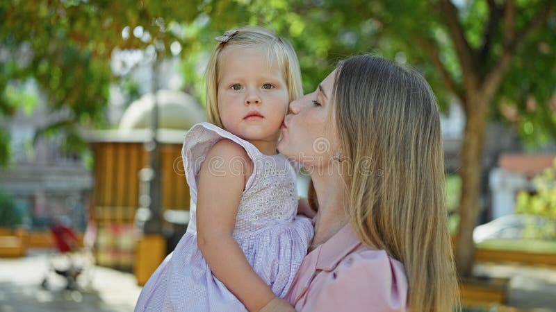 Cheerful Mother Hugging Standing With Her Girl In Arms Kissing