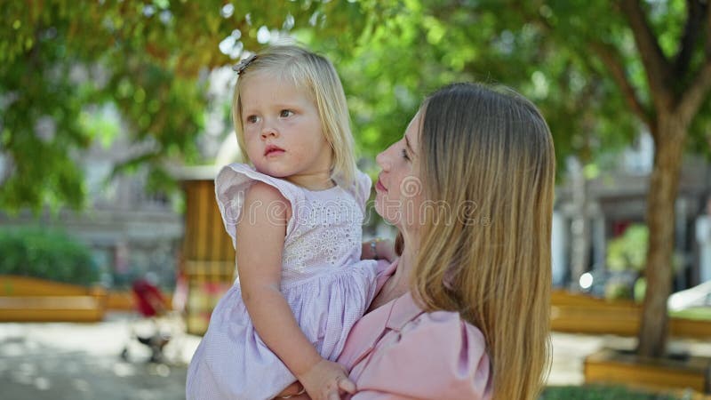 Cheerful Mother Hugging Standing With Her Girl In Arms Kissing