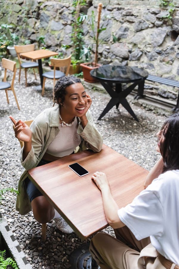 Cheerful Multiethnic Friends Talking Near Smartphone Stock Image ... Cheerful Multiethnic Friends Talking Near Smartphone Stock Image ...