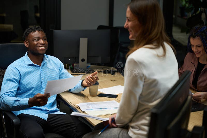 Team of Marketers Laughing Conducting Meeting in Coworking Space Office ...