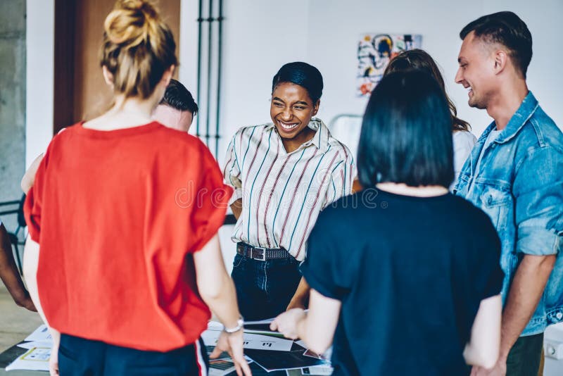Cheerful Multiracial People Discussing Working Process in Room Stock ...