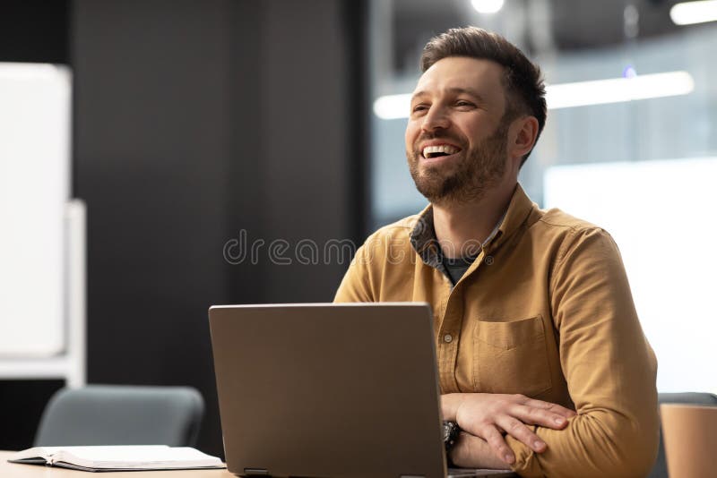 Cheerful Office Worker Man Working on Laptop Computer at Workplace ...