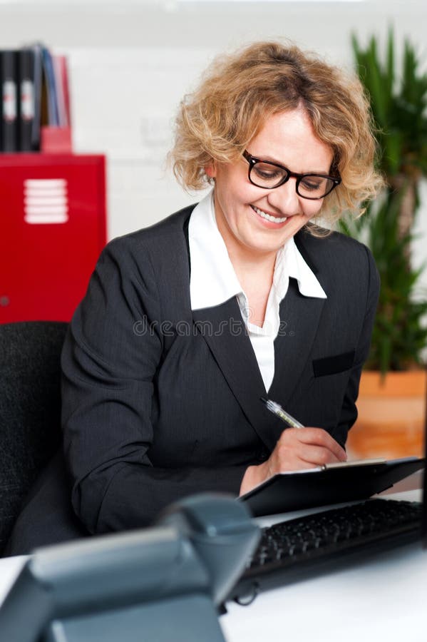 Cheerful Office Worker Writing Notes Stock Image - Image of middle ...